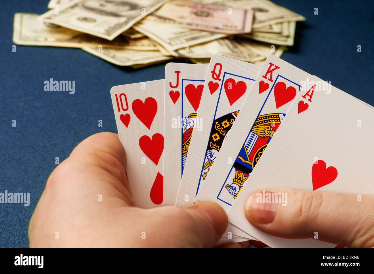 Man holding royal flush Stock Photo - Alamy