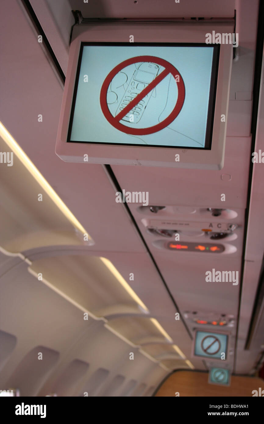 Overhead video monitor in flight no mobile phones Stock Photo - Alamy