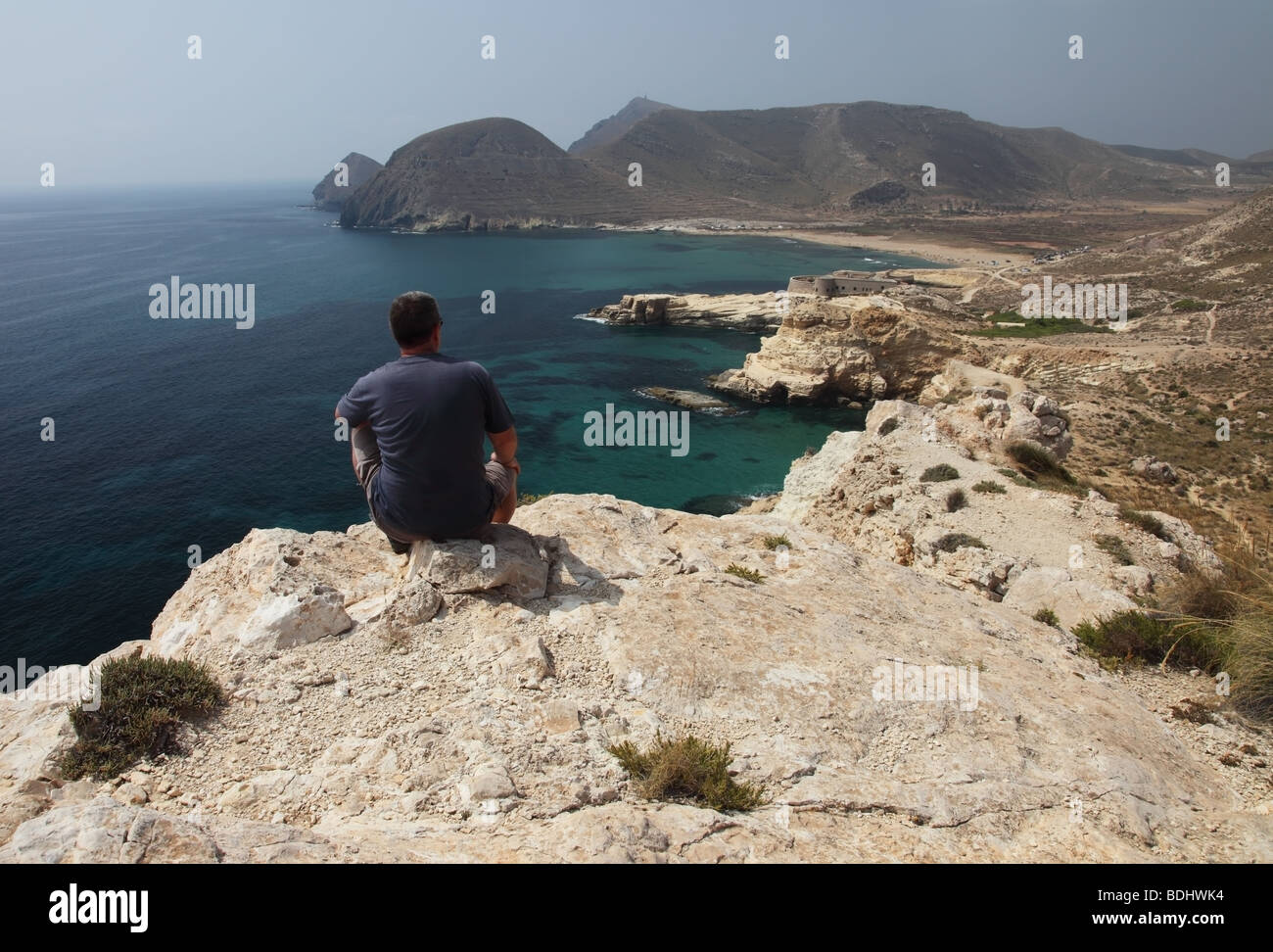 Walker Sitting on the Cliffs Above the Castillo de San Ramon Watching ...