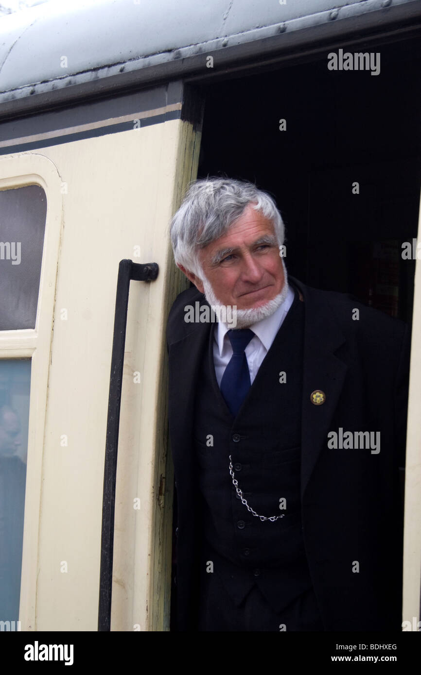 Guard on board a train on the South Devon Railway Stock Photo - Alamy