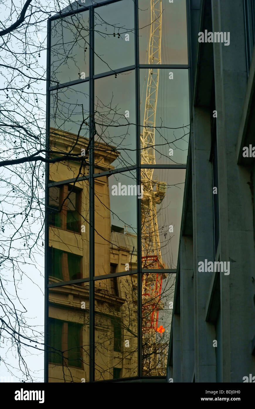 Reflections of building construction in a city office window Stock ...