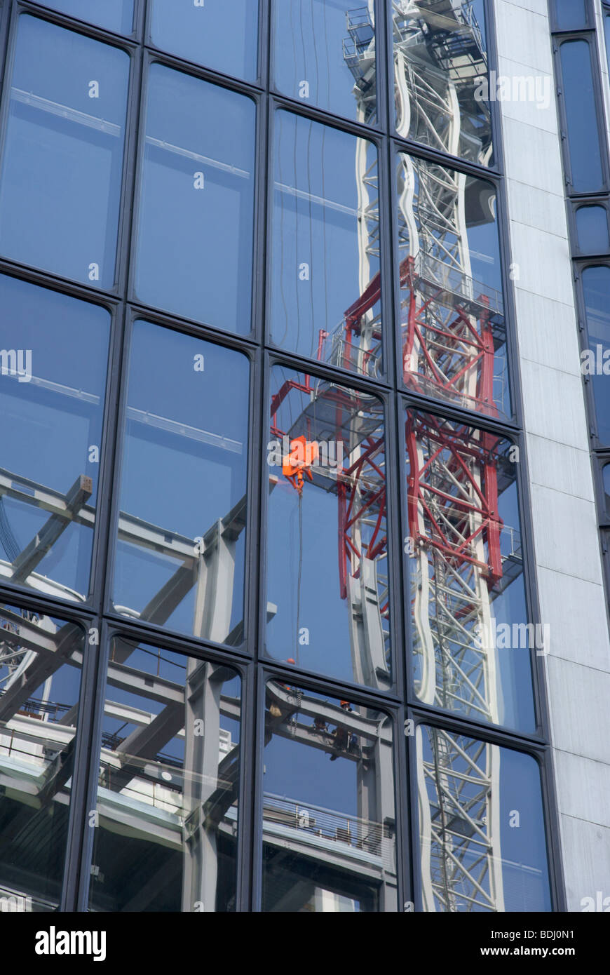Reflections of building construction in a city office window Stock ...