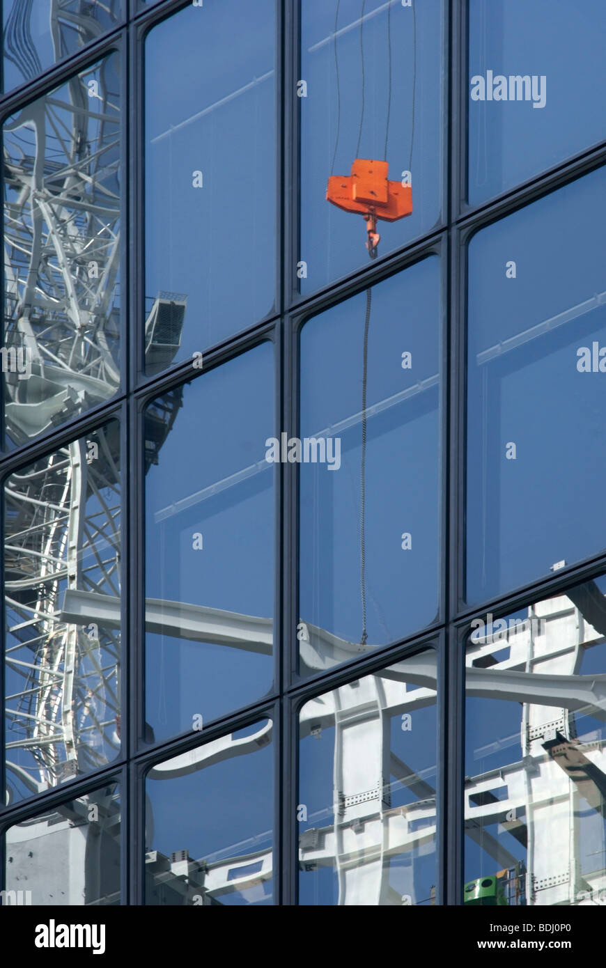 Reflections of building construction in a city office window Stock ...