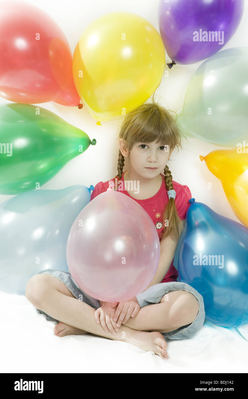 little happy giggle girl sitting with colour balloons. Girl celebrated ...