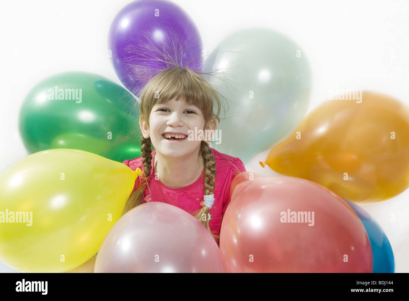 little happy giggle girl sitting with colour balloons. Girl celebrated ...