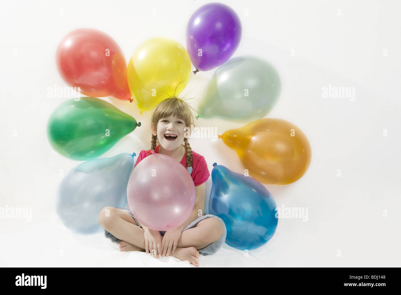 little happy giggle girl sitting with colour balloons. Girl celebrated ...