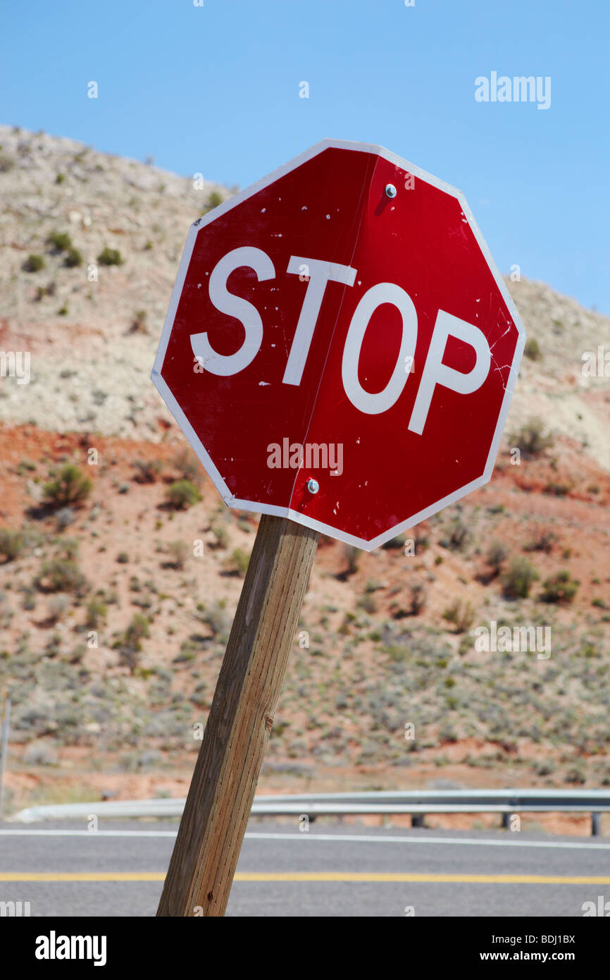 A stop sign next to a desert road Stock Photo - Alamy