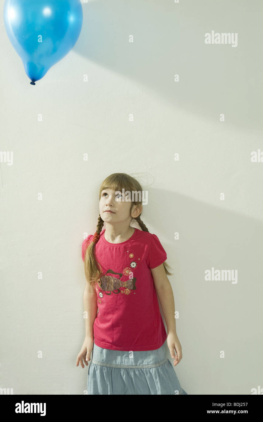 little happy giggle girl playing with colour balloons. Girl celebrates ...