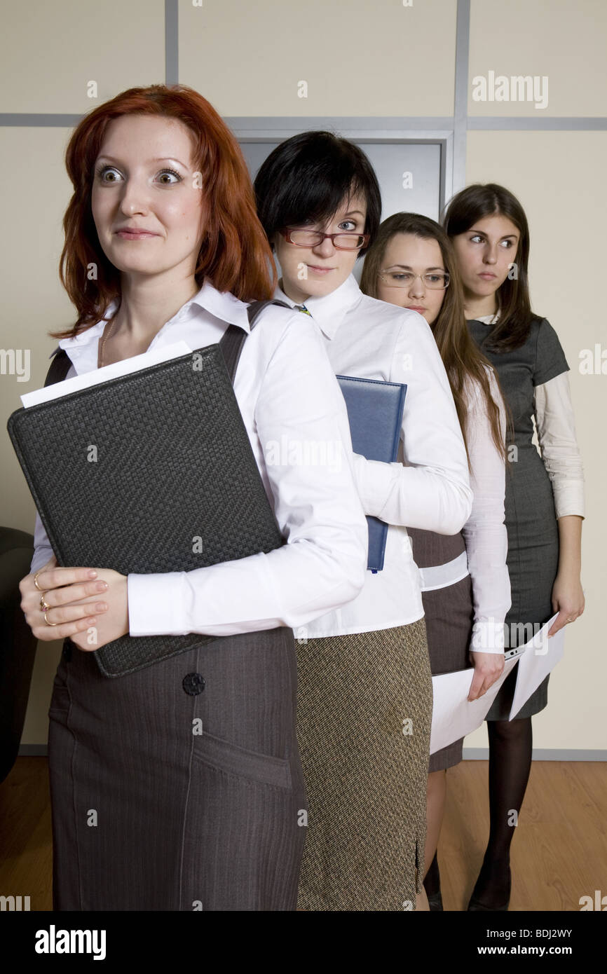 Businesswoman leading a business team in an office smiling. Secretaries ...