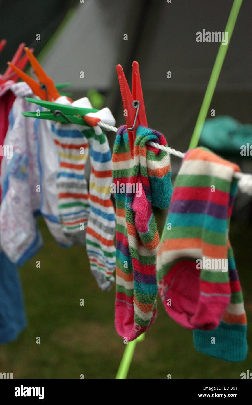 Socks hanging on a washing line at a campsite Stock Photo - Alamy