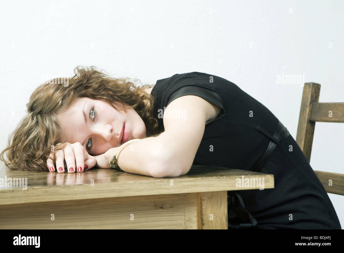 upset girl put her head down table. Woman`s problem Stock Photo - Alamy