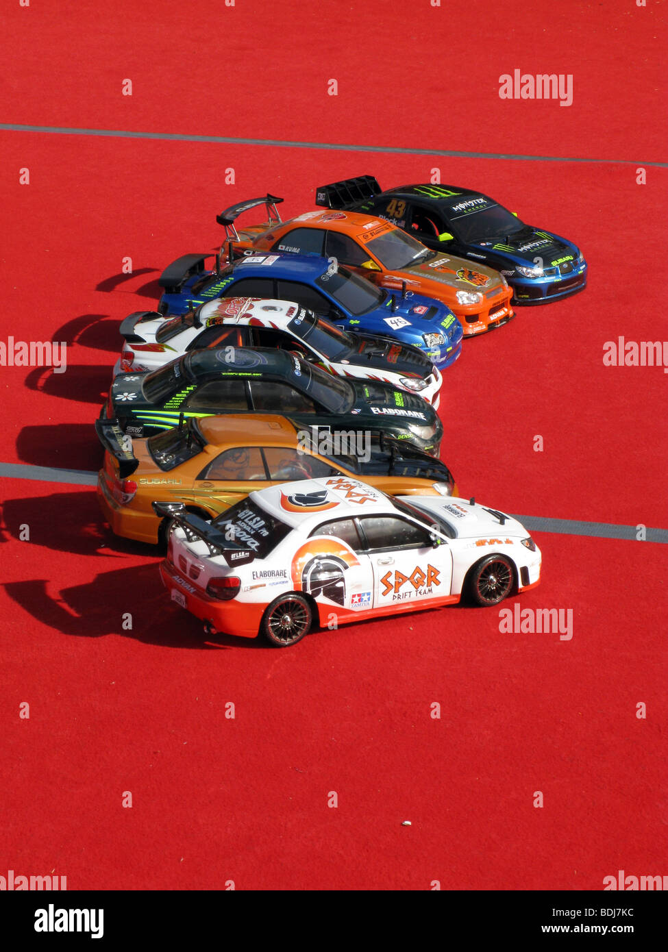 row of toy racing cars on red carpet Stock Photo - Alamy