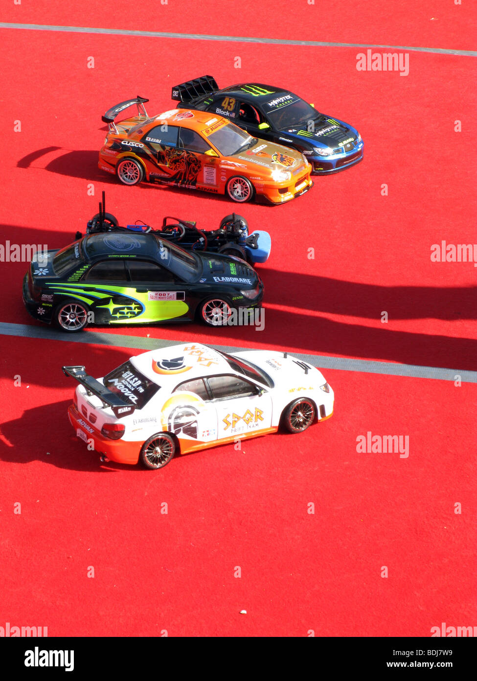 row of toy racing cars on red carpet Stock Photo - Alamy