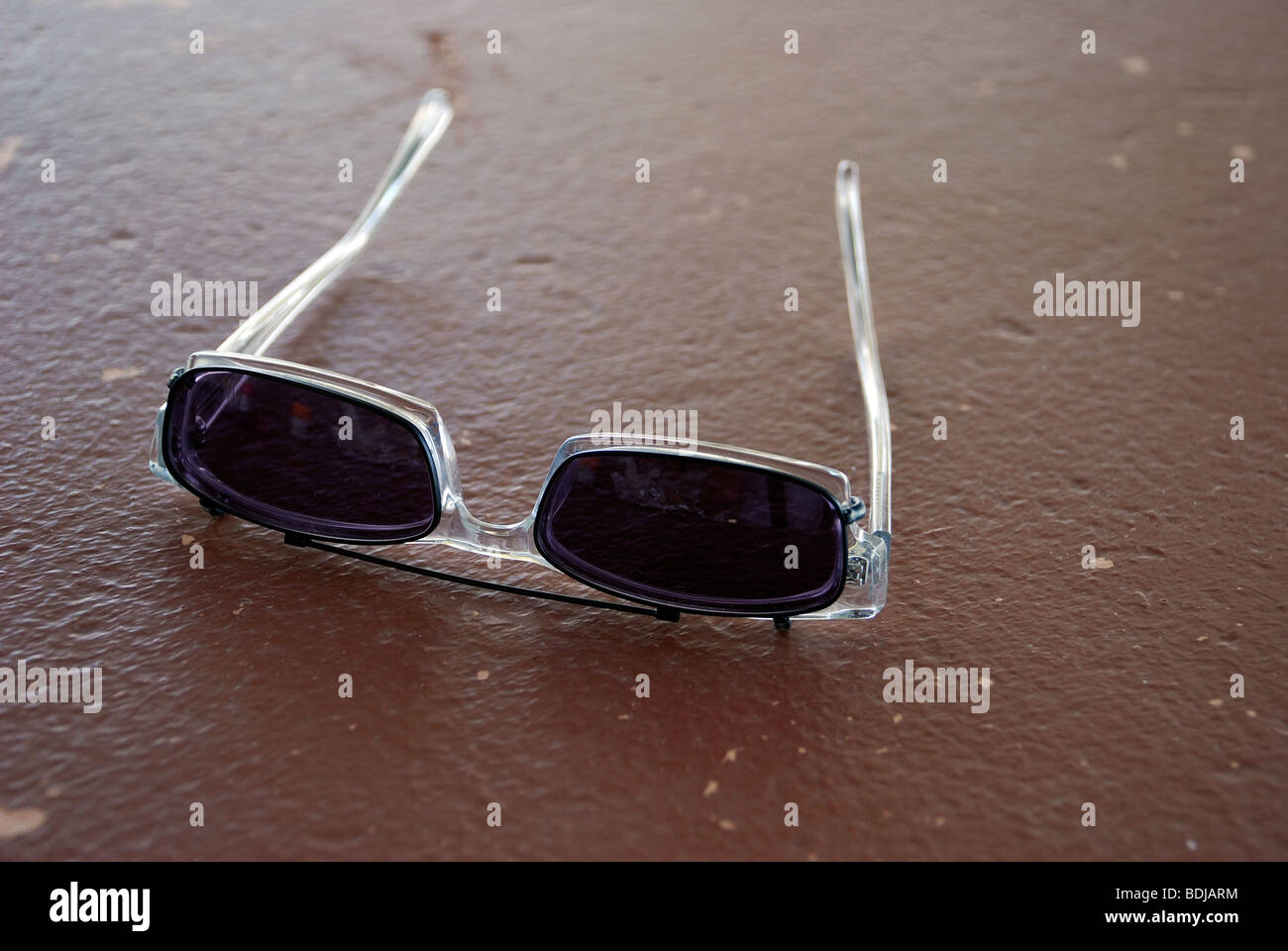 Glasses with sun shade clip-ons on table Stock Photo - Alamy