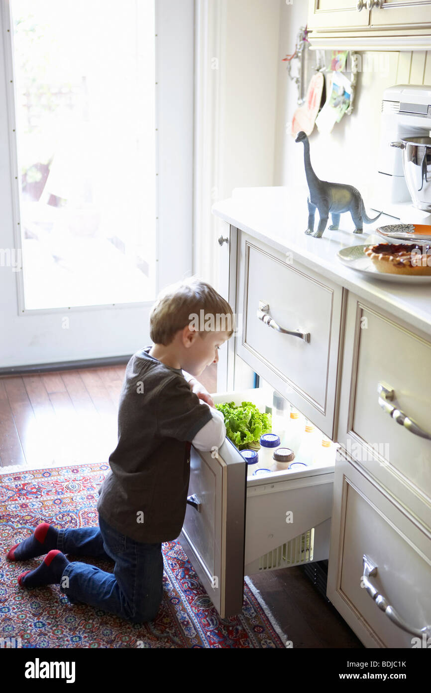 Boy Looking in Open Drawer Stock Photo - Alamy