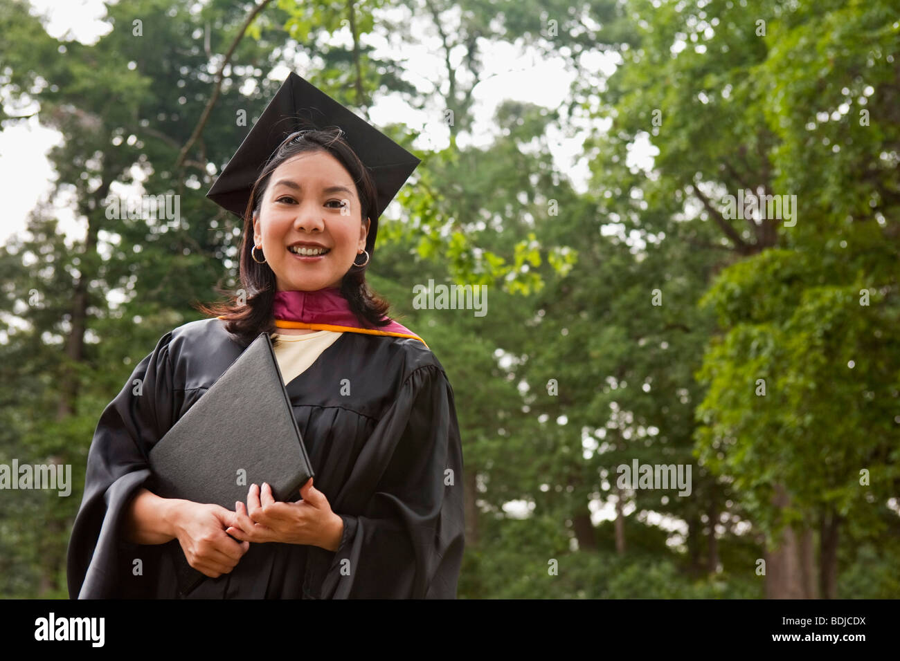 Graduated woman celebrating diploma over hi-res stock photography and ...