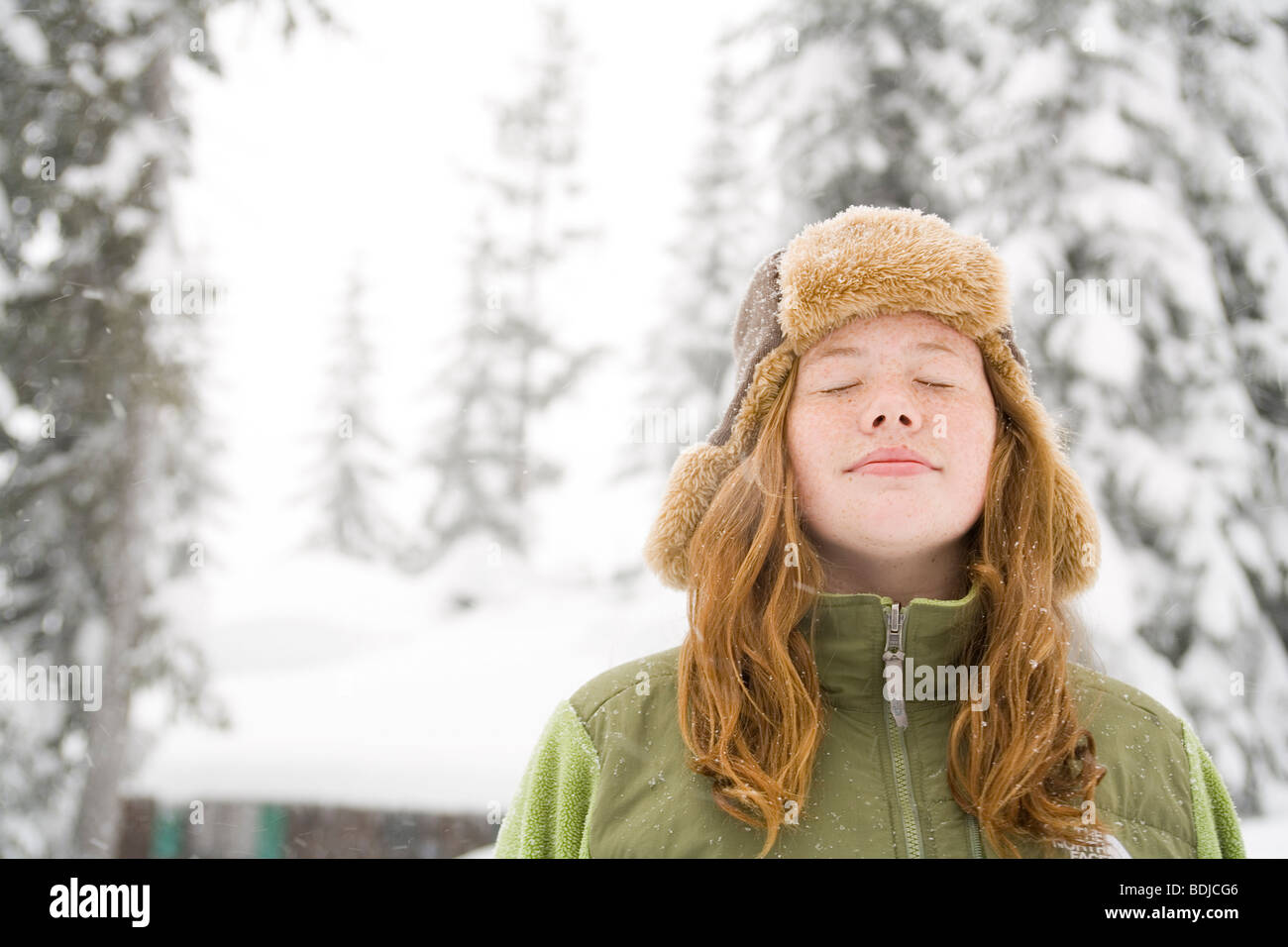 Girl Outdoors During Snowfall Stock Photo - Alamy