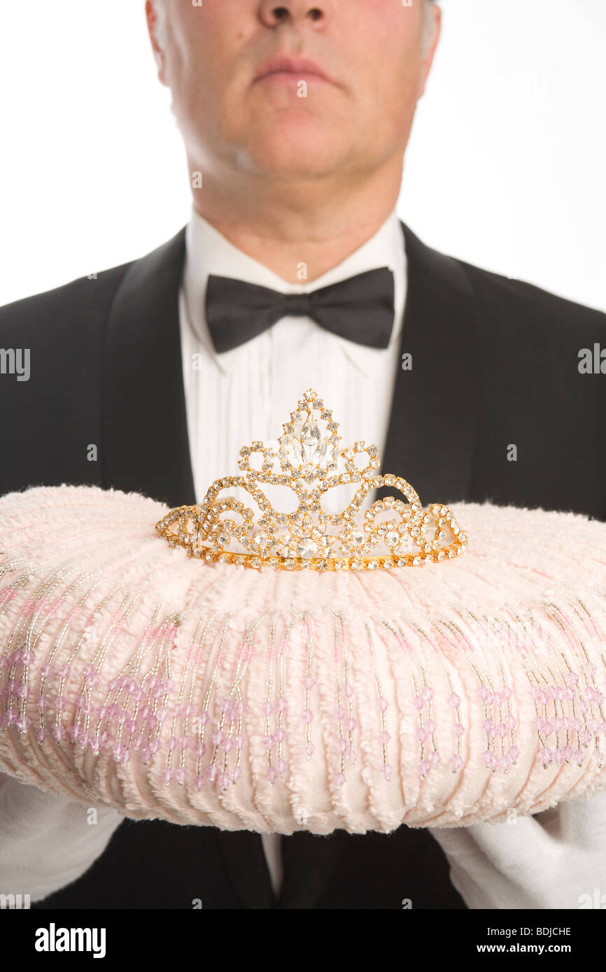 Butler Holding a Tiara on a Cushion Stock Photo - Alamy