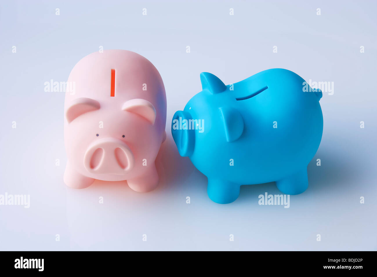 Two piggy banks one white one pink hi-res stock photography and images ...