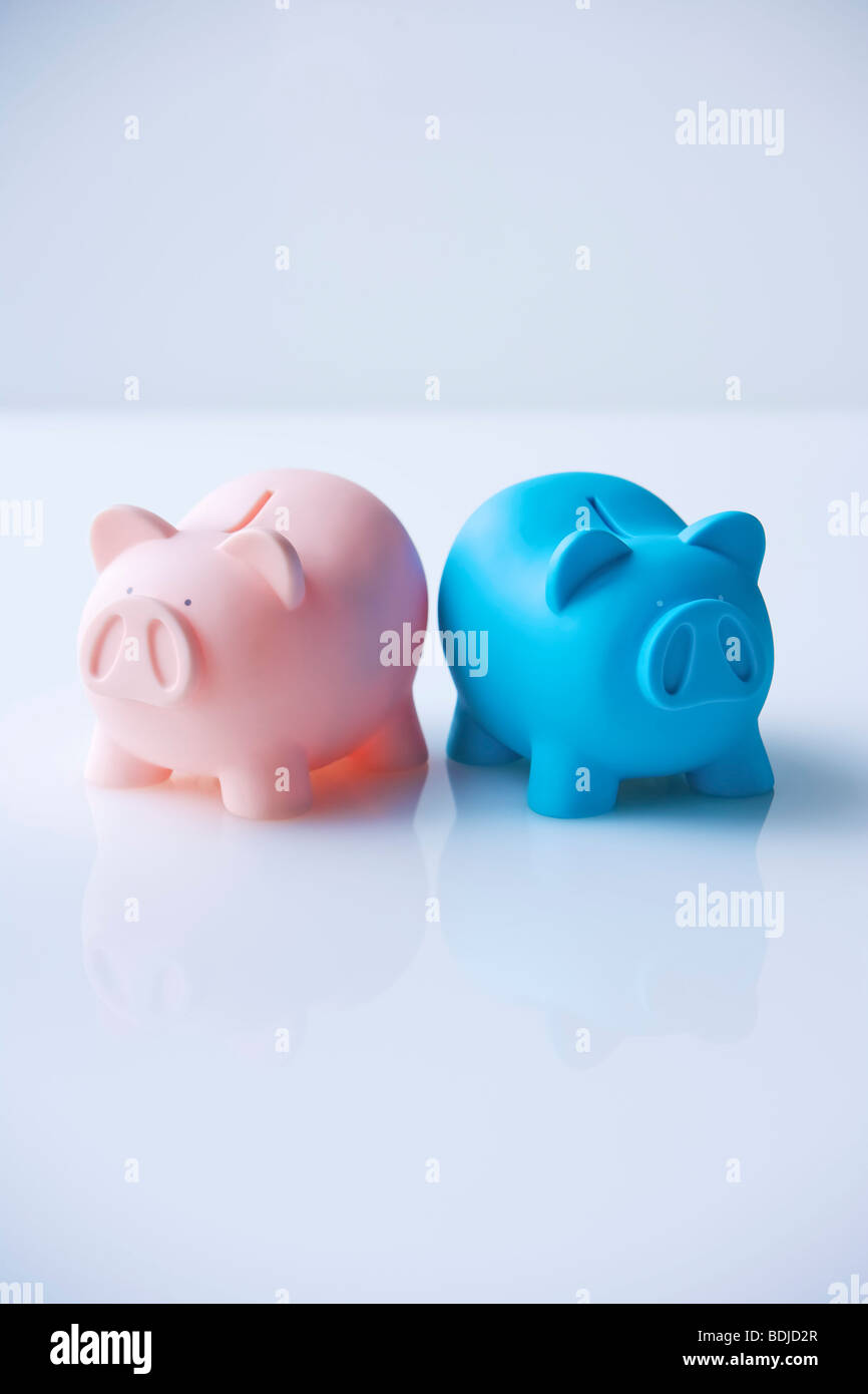 Two piggy banks one white one pink hi-res stock photography and images ...