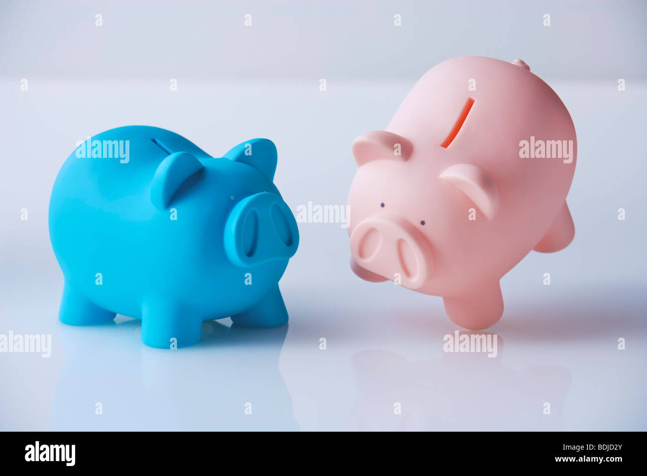Comparing two piggy banks hi-res stock photography and images - Alamy