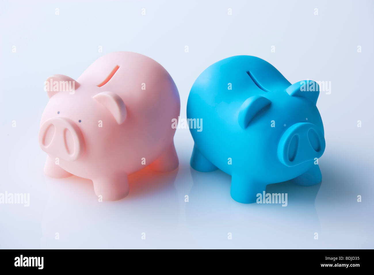 Two piggy banks one white one pink hi-res stock photography and images ...