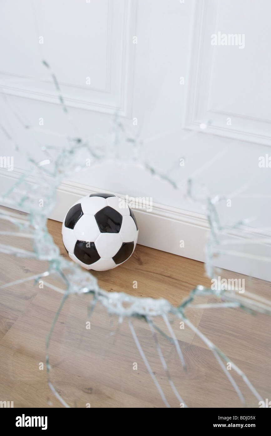 Soccer Ball and Broken Window Stock Photo - Alamy