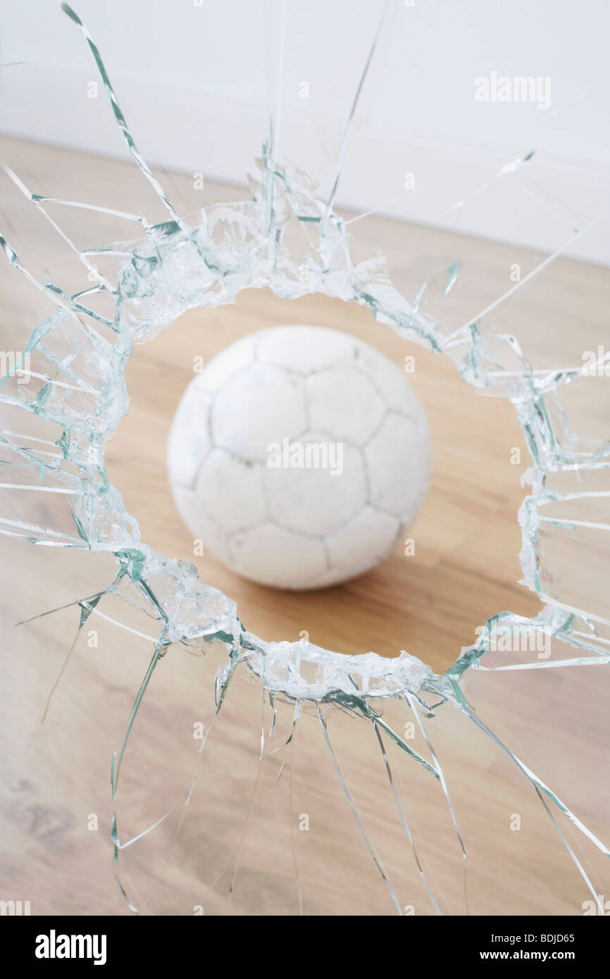 Soccer Ball and Broken Window Stock Photo - Alamy