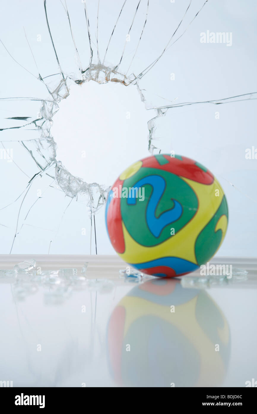 Colourful Ball and Broken Window Stock Photo - Alamy