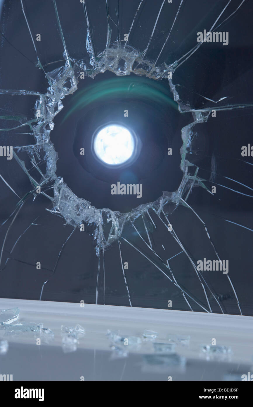 Hand Holding Flashlight Through Broken Window Stock Photo - Alamy