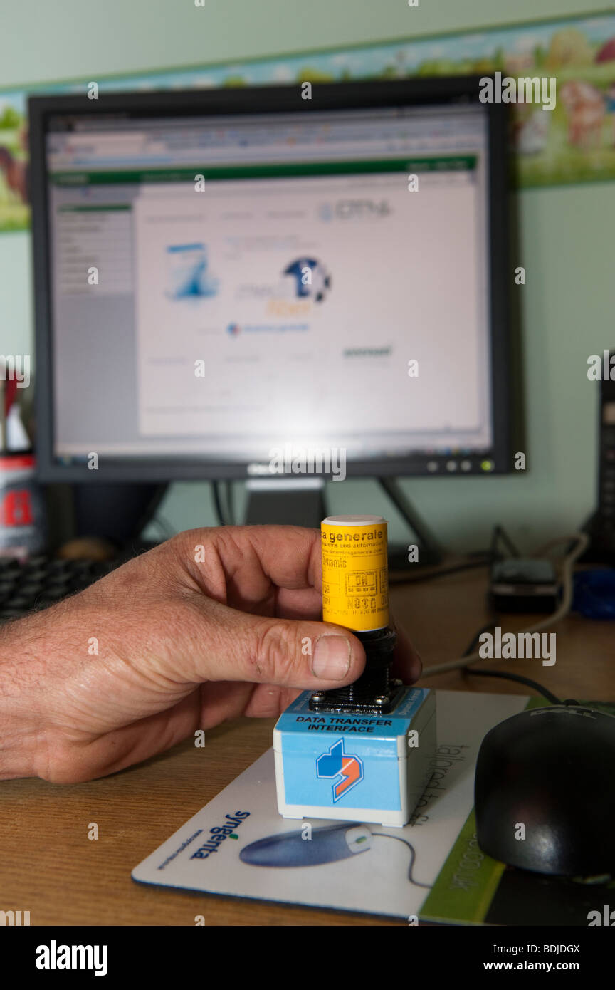Farmer putting a PACE electronic feed management system linked into the ...