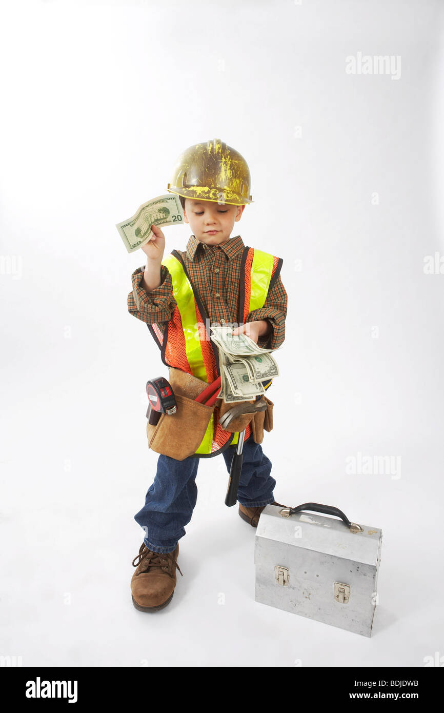 Boy Dressed Up as Construction Worker Holding Money Stock Photo - Alamy