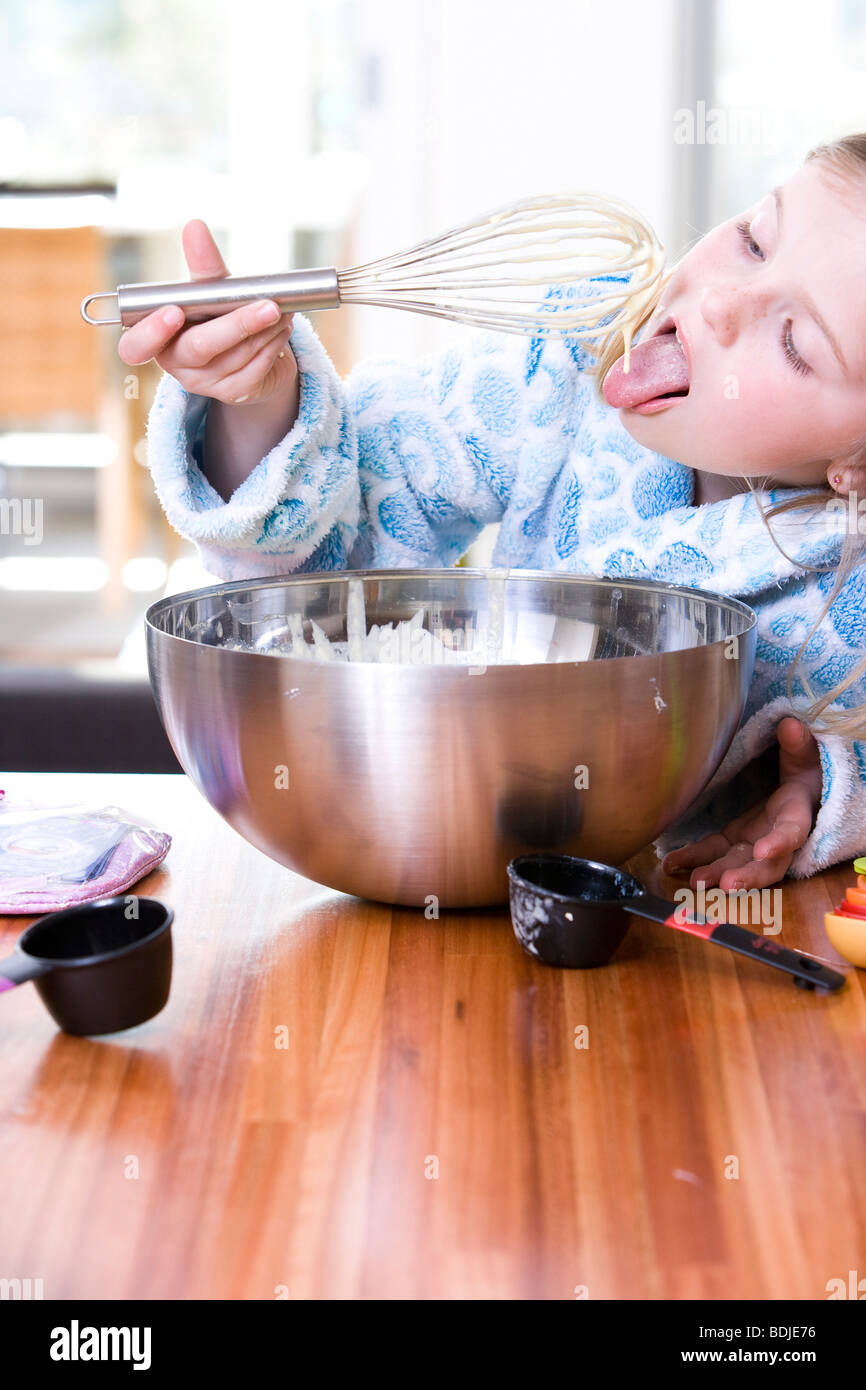 Little Girl Baking, Eating the Batter Stock Photo - Alamy