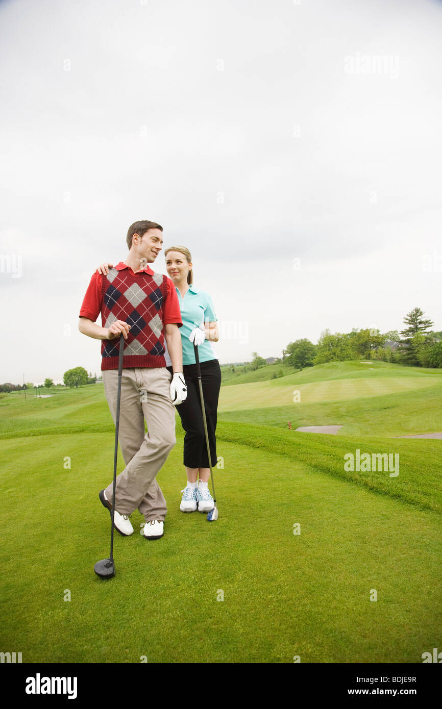Couple Standing on Golf Course Stock Photo - Alamy