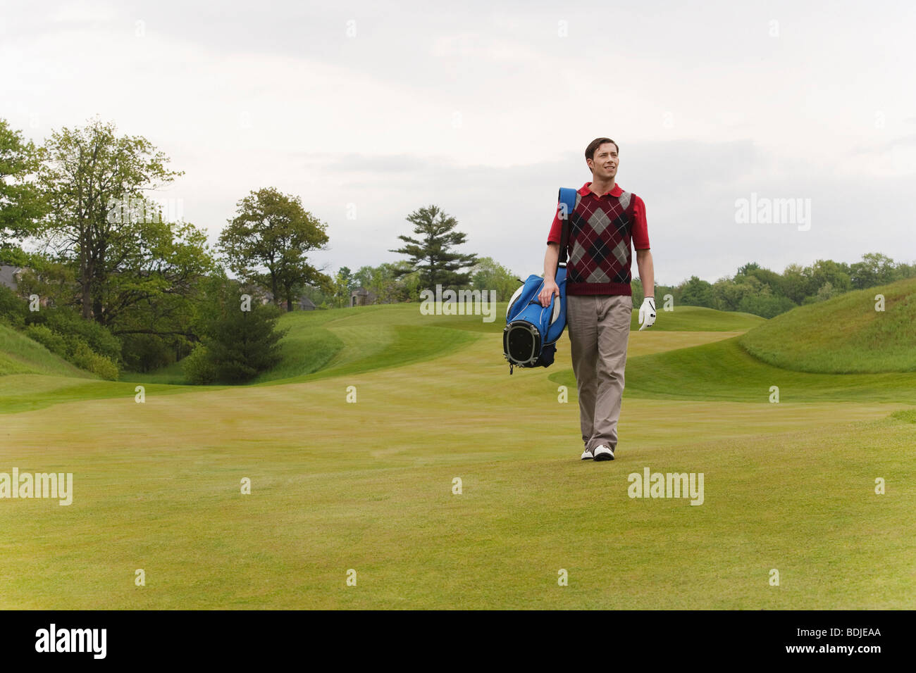 Man Walking on Golf Course Stock Photo - Alamy