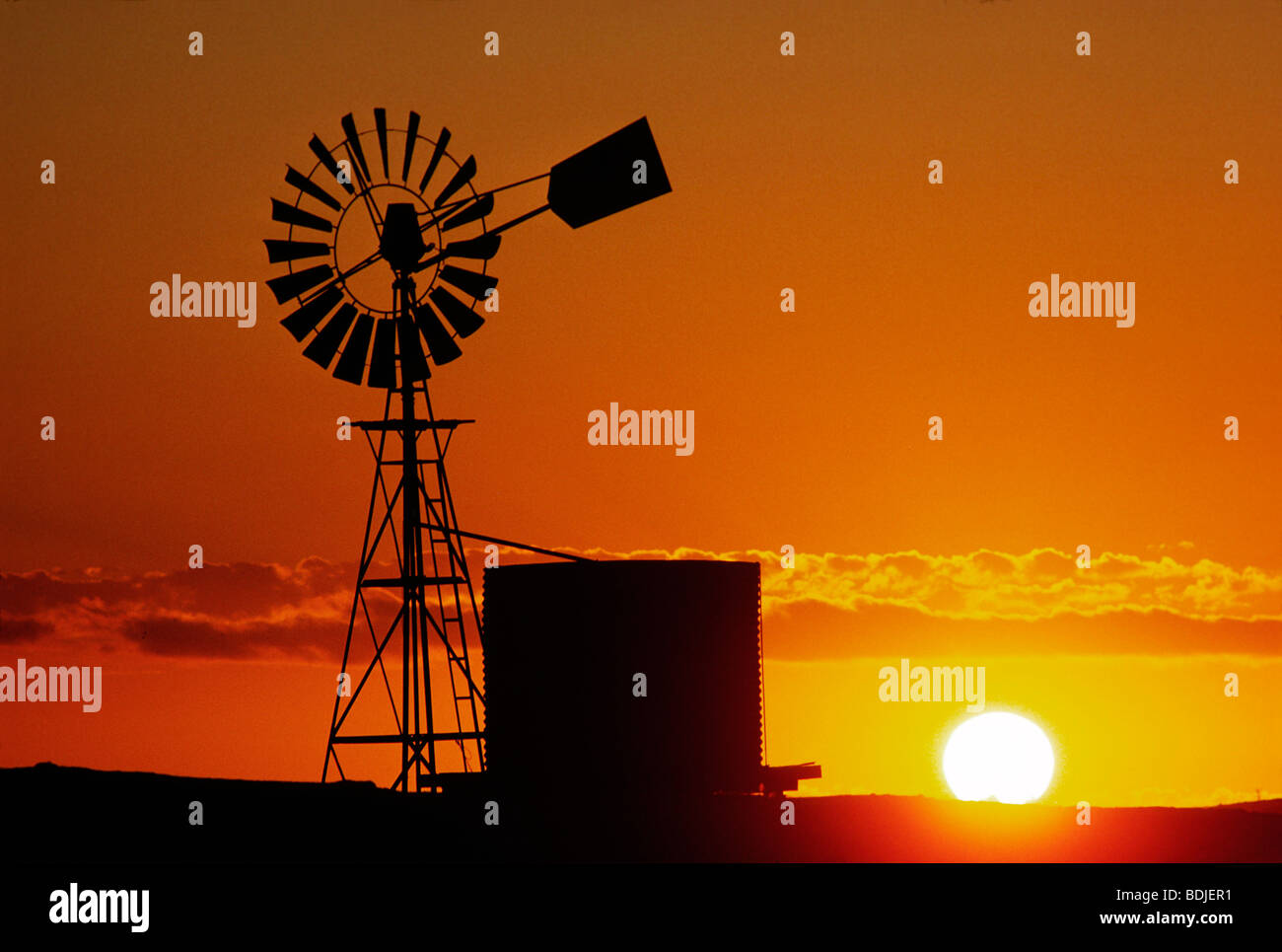 Windmill and Water Tank, Sunset Silhouette Stock Photo - Alamy