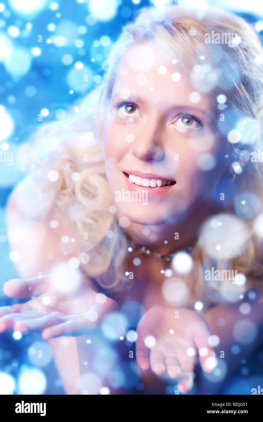 Young romantic woman catching falling flakes Stock Photo - Alamy