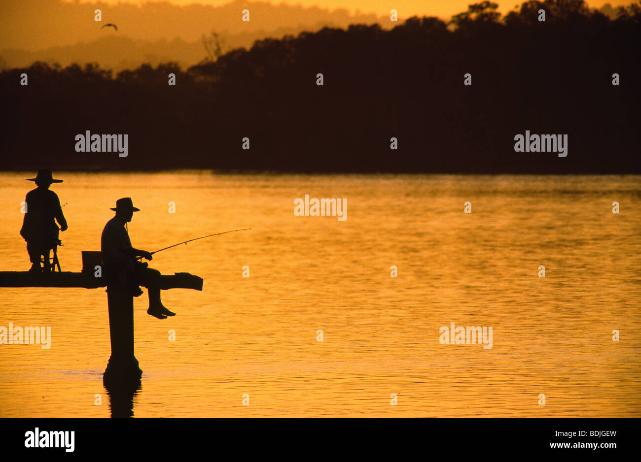Sunset silhouette fishing from dock hi-res stock photography and images ...
