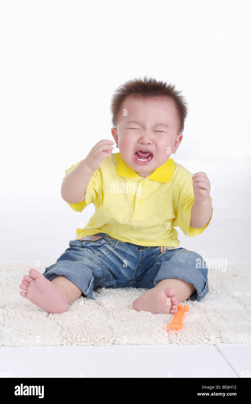 Baby boy sitting and crying,Child Stock Photo - Alamy