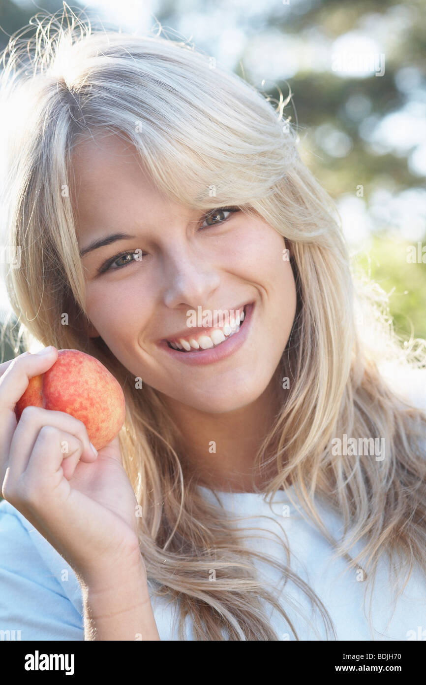 Holding a peach to camera hi-res stock photography and images - Alamy