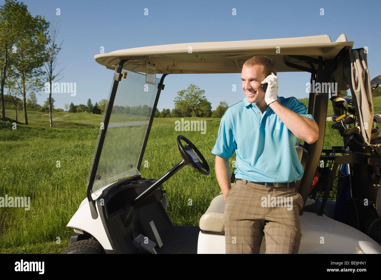 Man using Cell Phone on Golf Course Stock Photo - Alamy