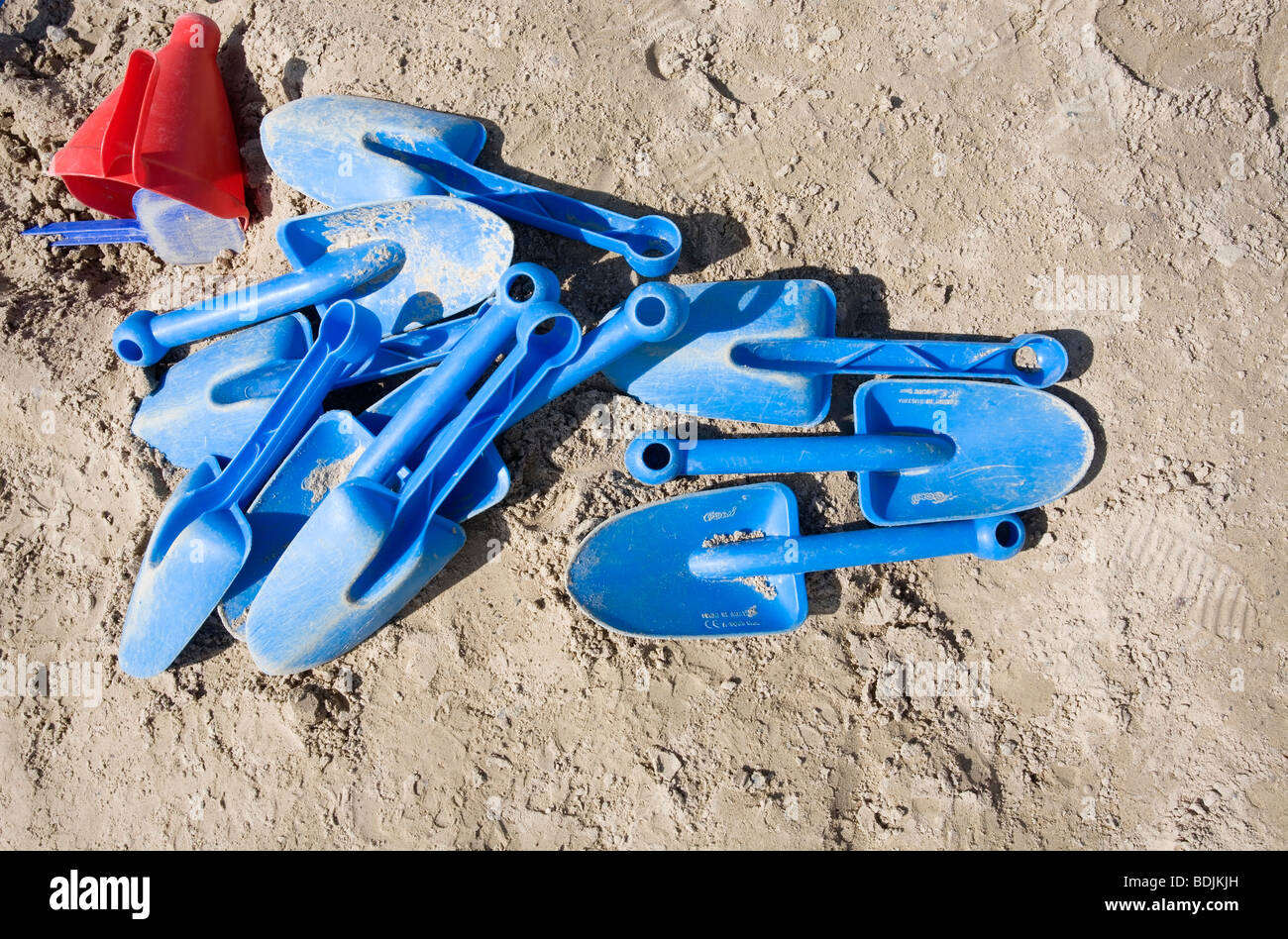 plastic toy spades on sand Stock Photo - Alamy