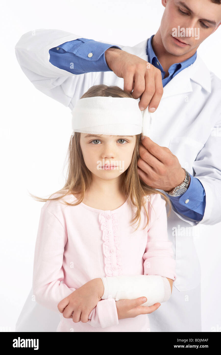 Doctor Wrapping Bandage Around Girl's Head Stock Photo - Alamy