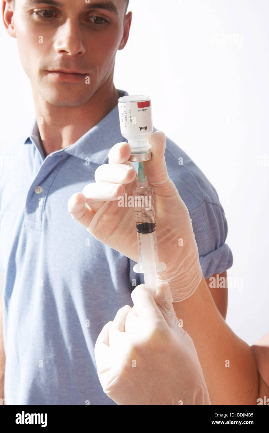 Young female nurse holding hypodermic syringe hi-res stock photography ...