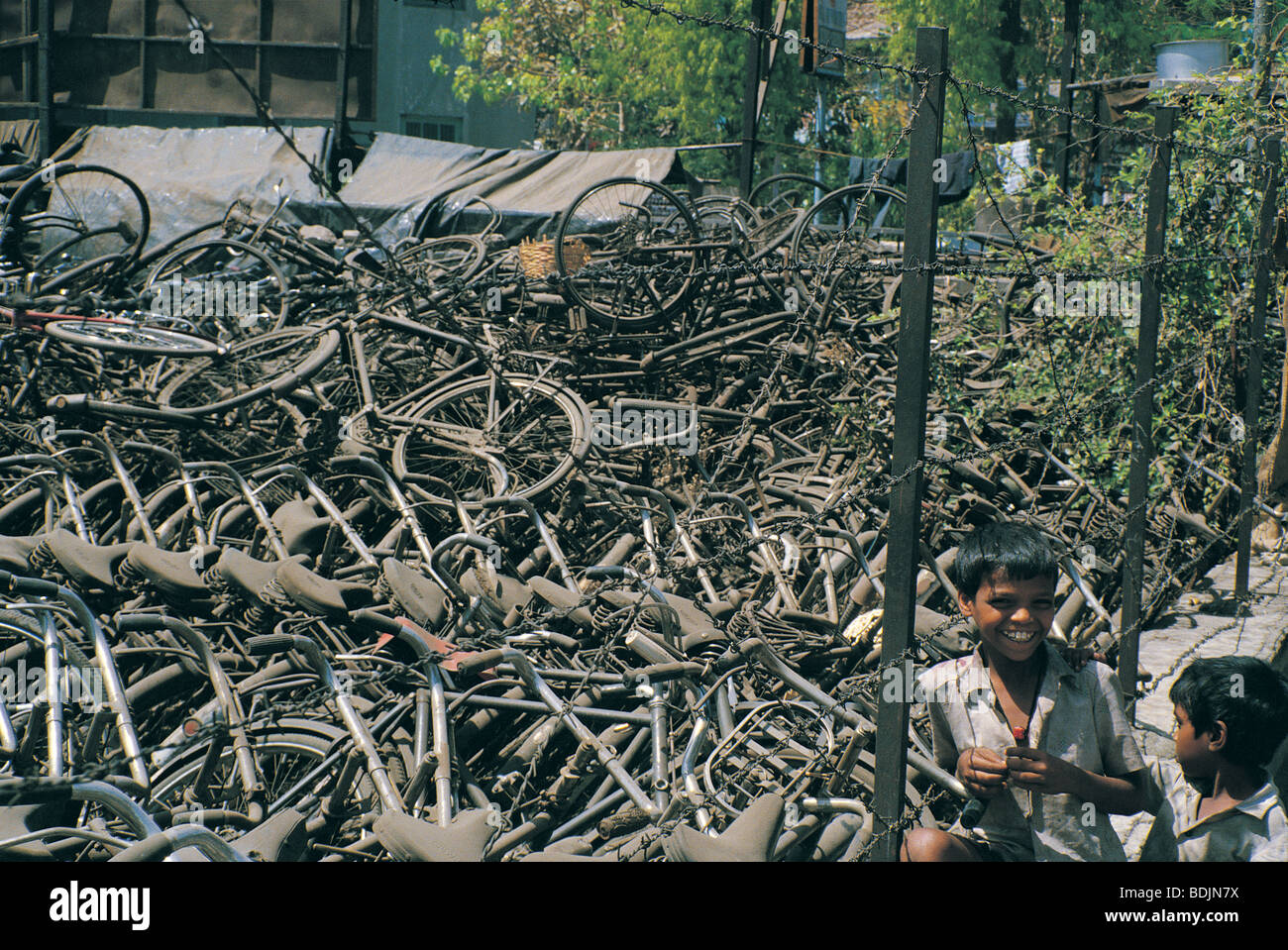 Big stack of dusty Indian bicycles outside a train station with two ...