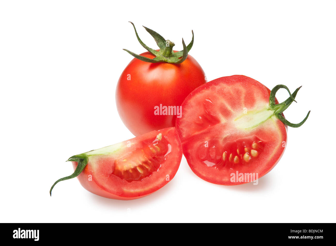 The cut tomatoes. It is isolated on a white background Stock Photo - Alamy