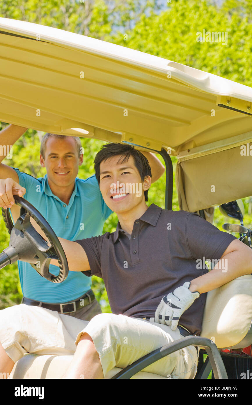 Two men riding golf cart hi-res stock photography and images - Alamy