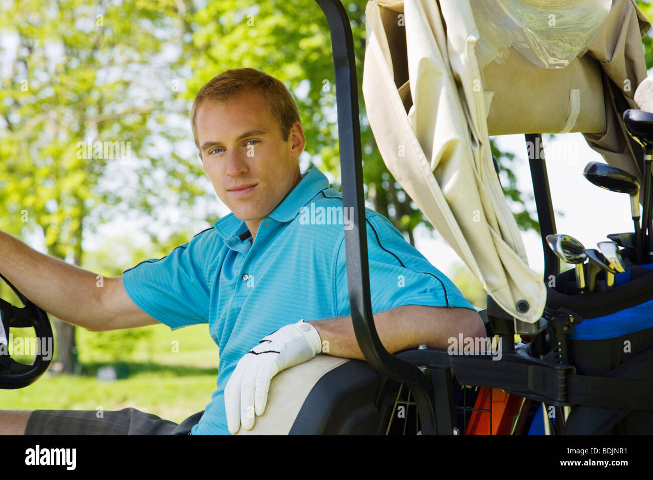 Man in Golf Cart Stock Photo - Alamy