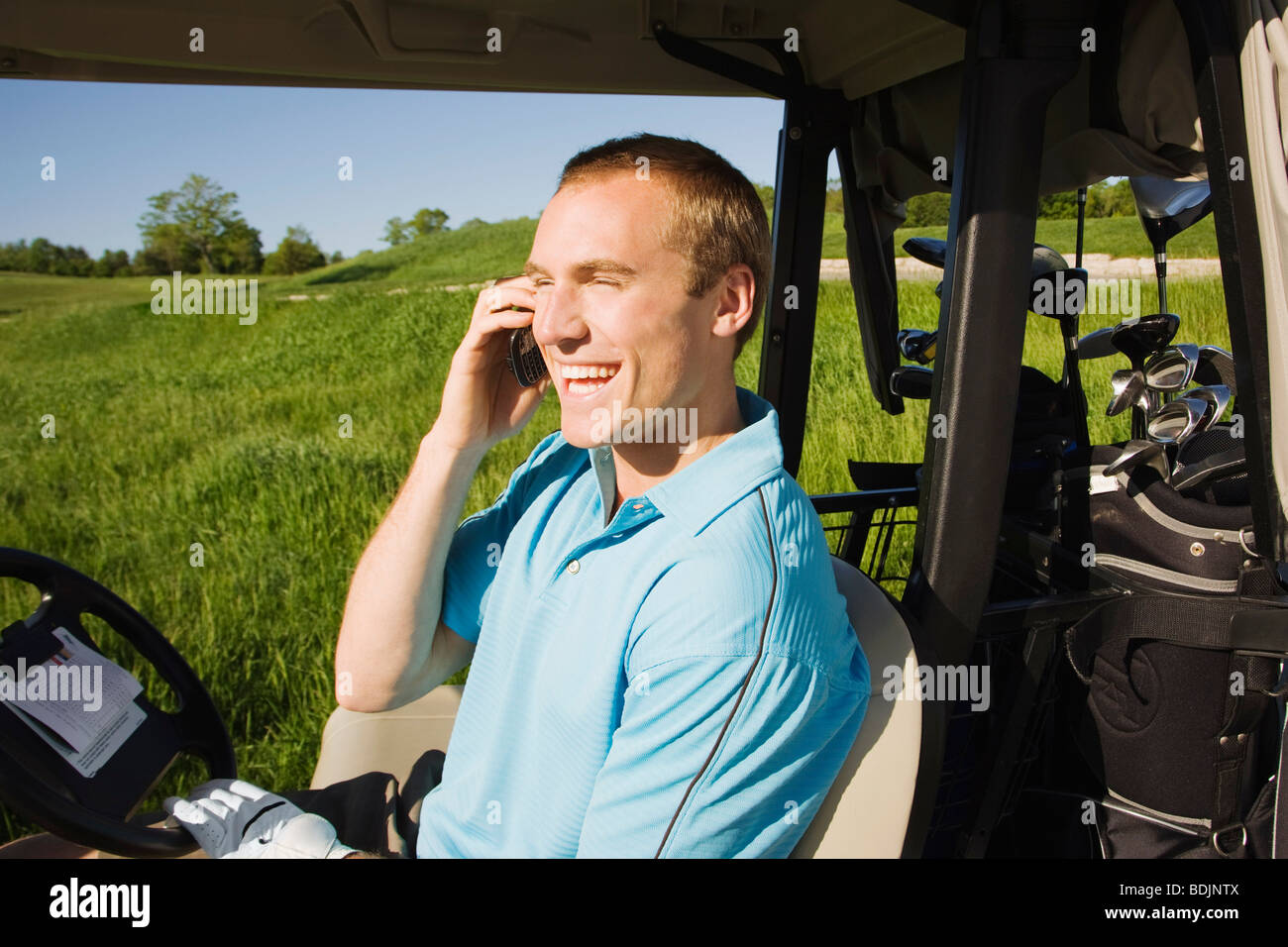 Man Riding Golf Cart Stock Photo - Alamy