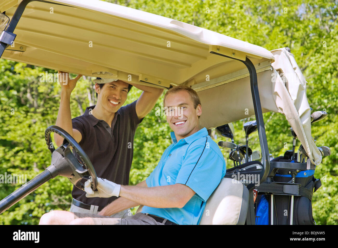 Men in Golf Cart Stock Photo - Alamy